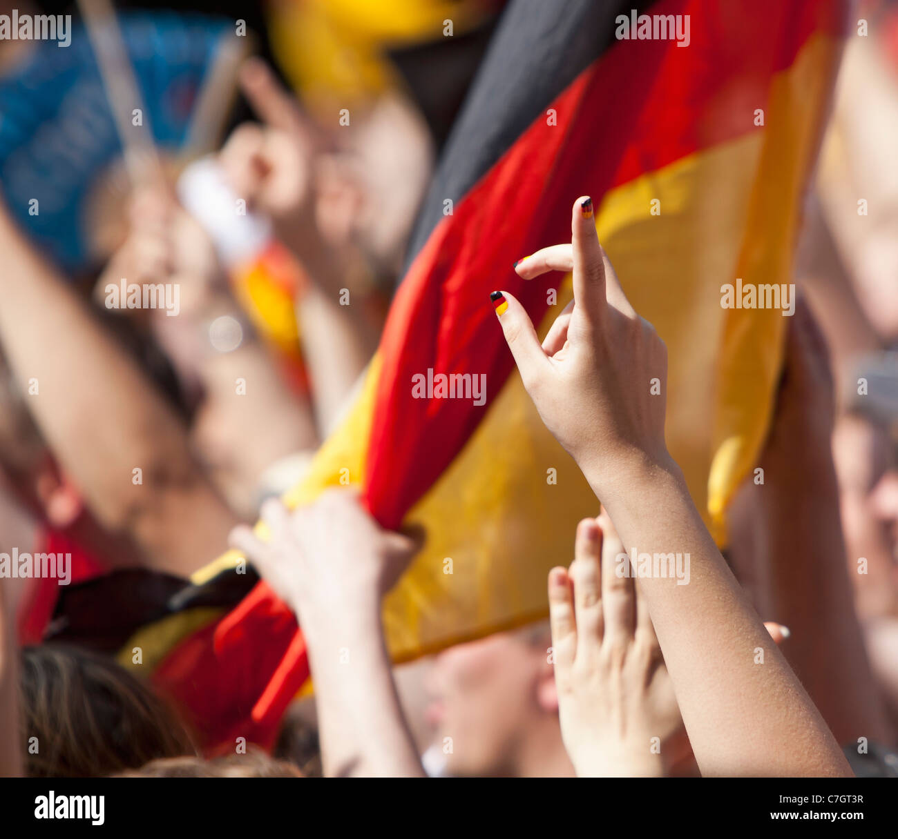 Detail of a woman raising her finger in a crowd Stock Photo - Alamy
