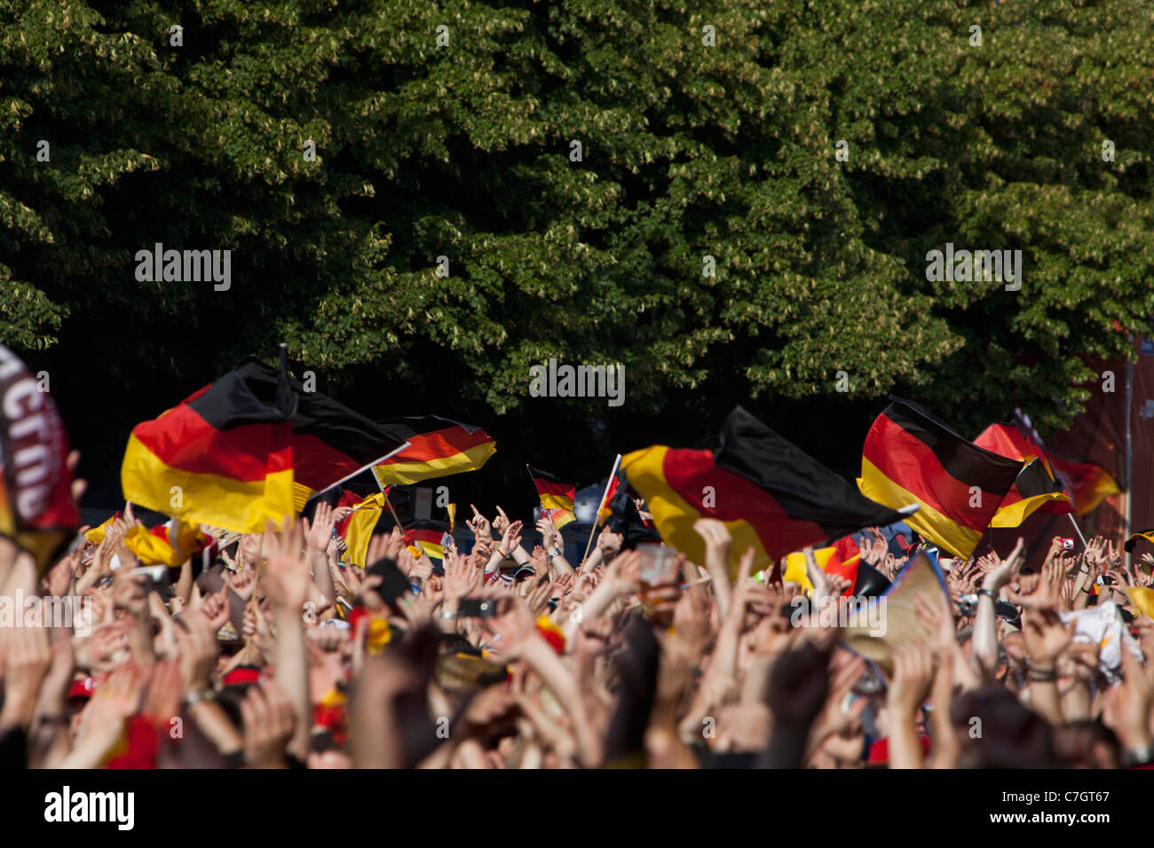 Detail of people in a crowd waving German flags Stock Photo - Alamy