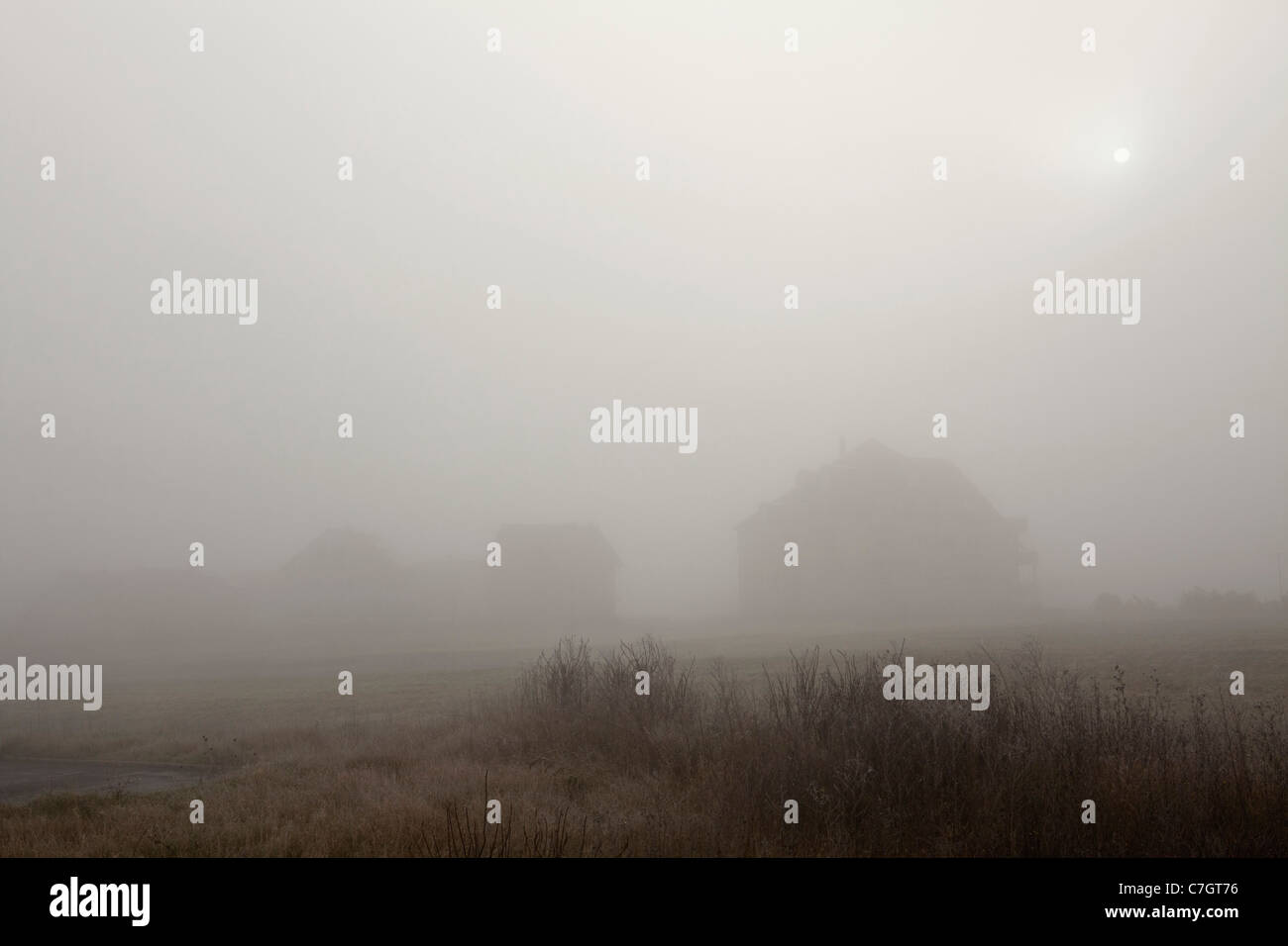 Buildings in a misty field Stock Photo - Alamy