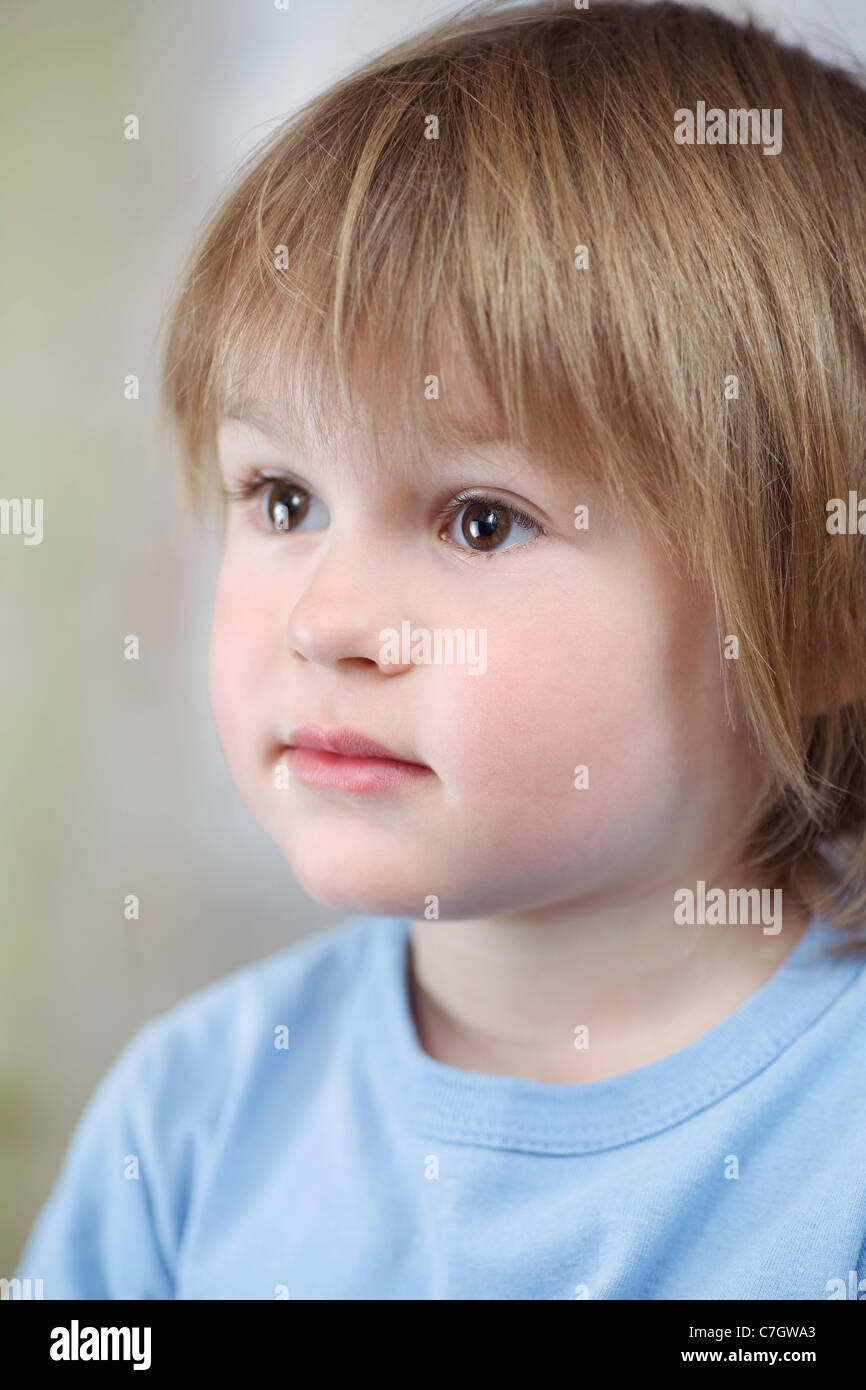 A young boy staring off camera Stock Photo - Alamy