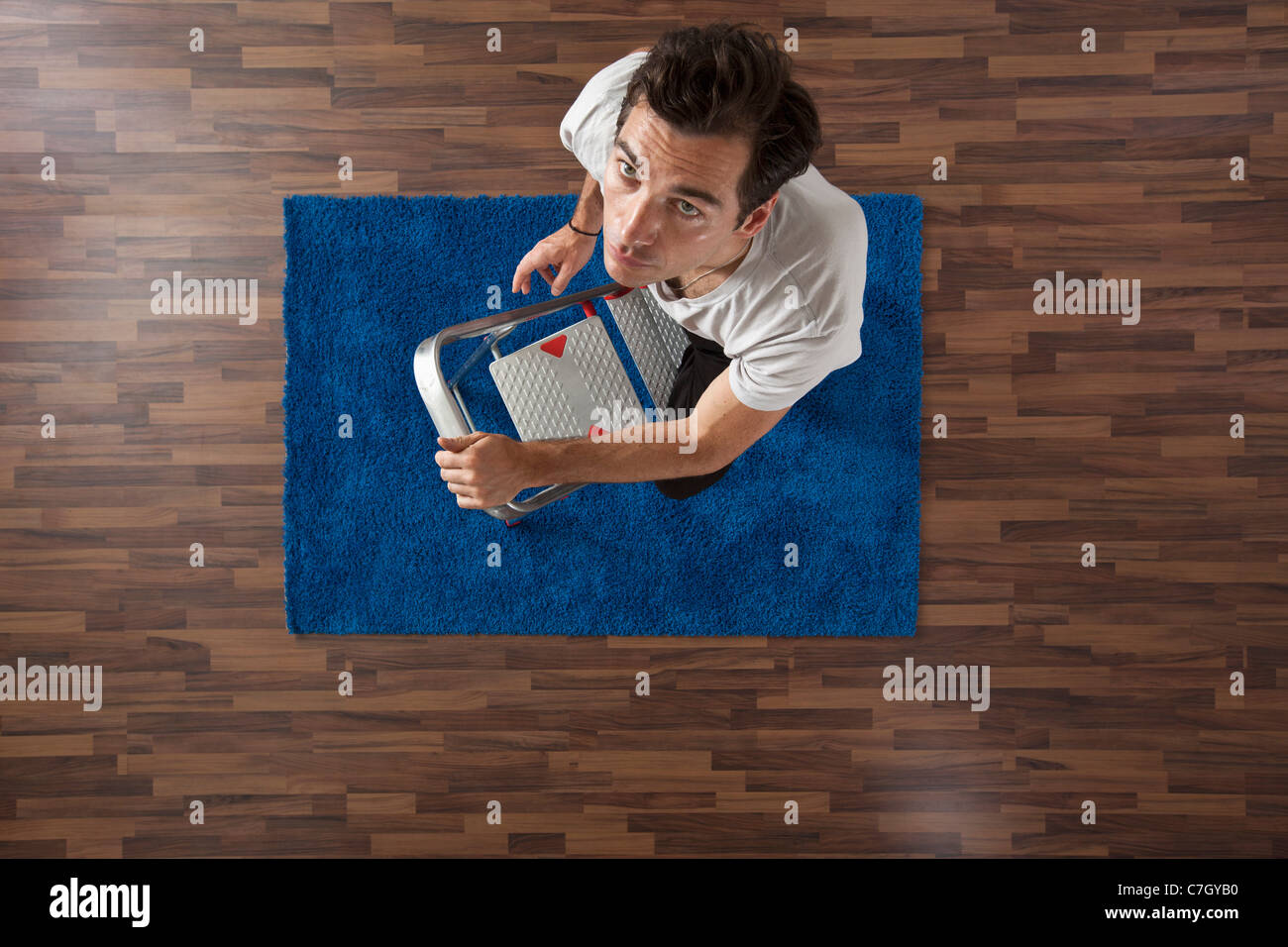 Man climbing a ladder looking up, overhead view Stock Photo - Alamy