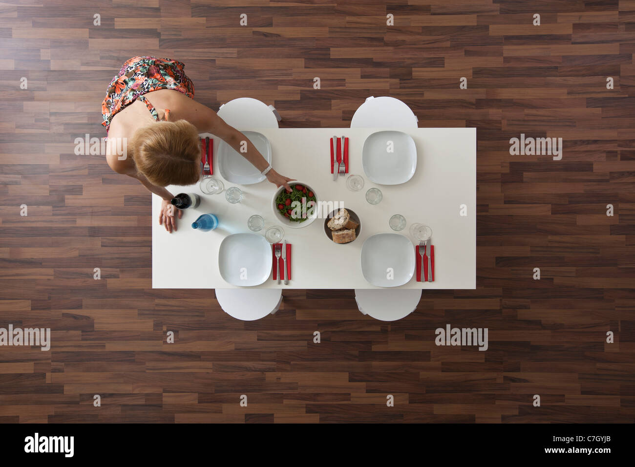 Woman setting dining room table for dinner party, overhead view Stock ...