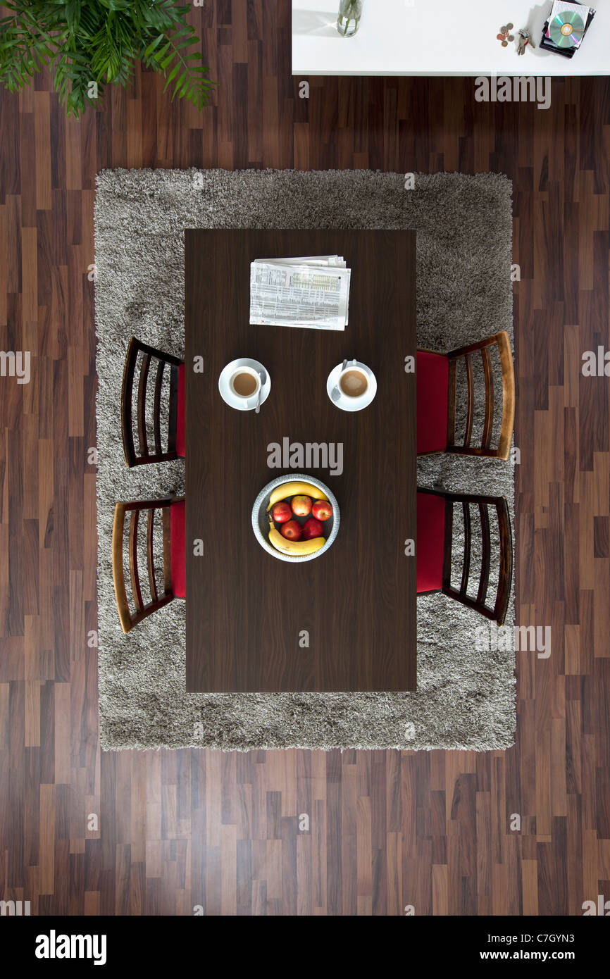 A dining table with coffee cups and newspaper, overhead view Stock ...