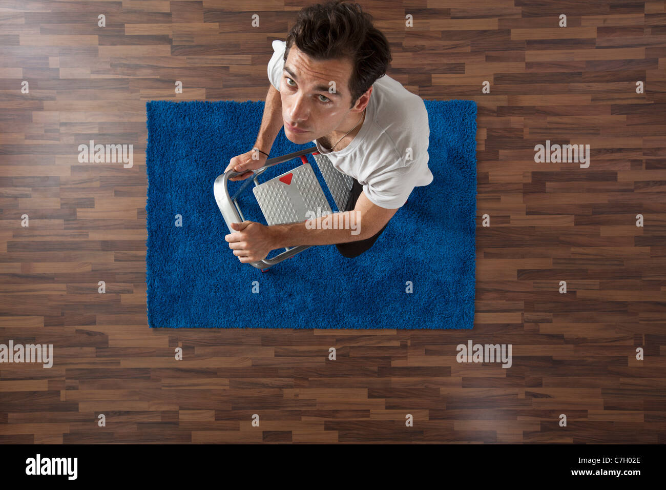 Man climbing a ladder looking up, overhead view Stock Photo - Alamy
