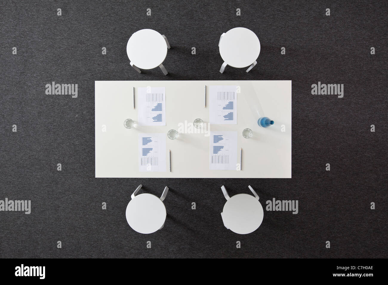 A set conference table prepared for a business meeting, overhead view ...