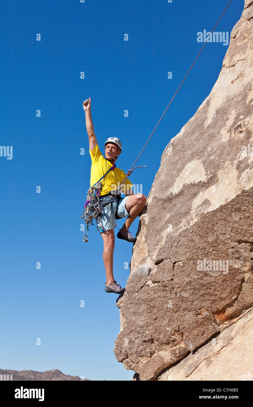 Male rock climber celebrates after a successful ascent Stock Photo - Alamy