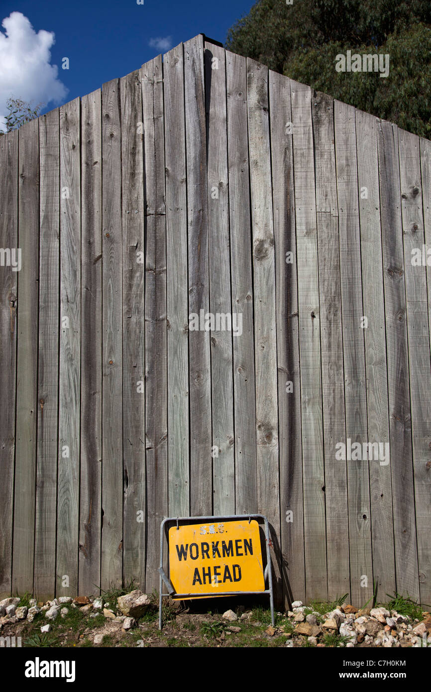 Workmen Ahead sign leaning against a wood building Stock Photo - Alamy