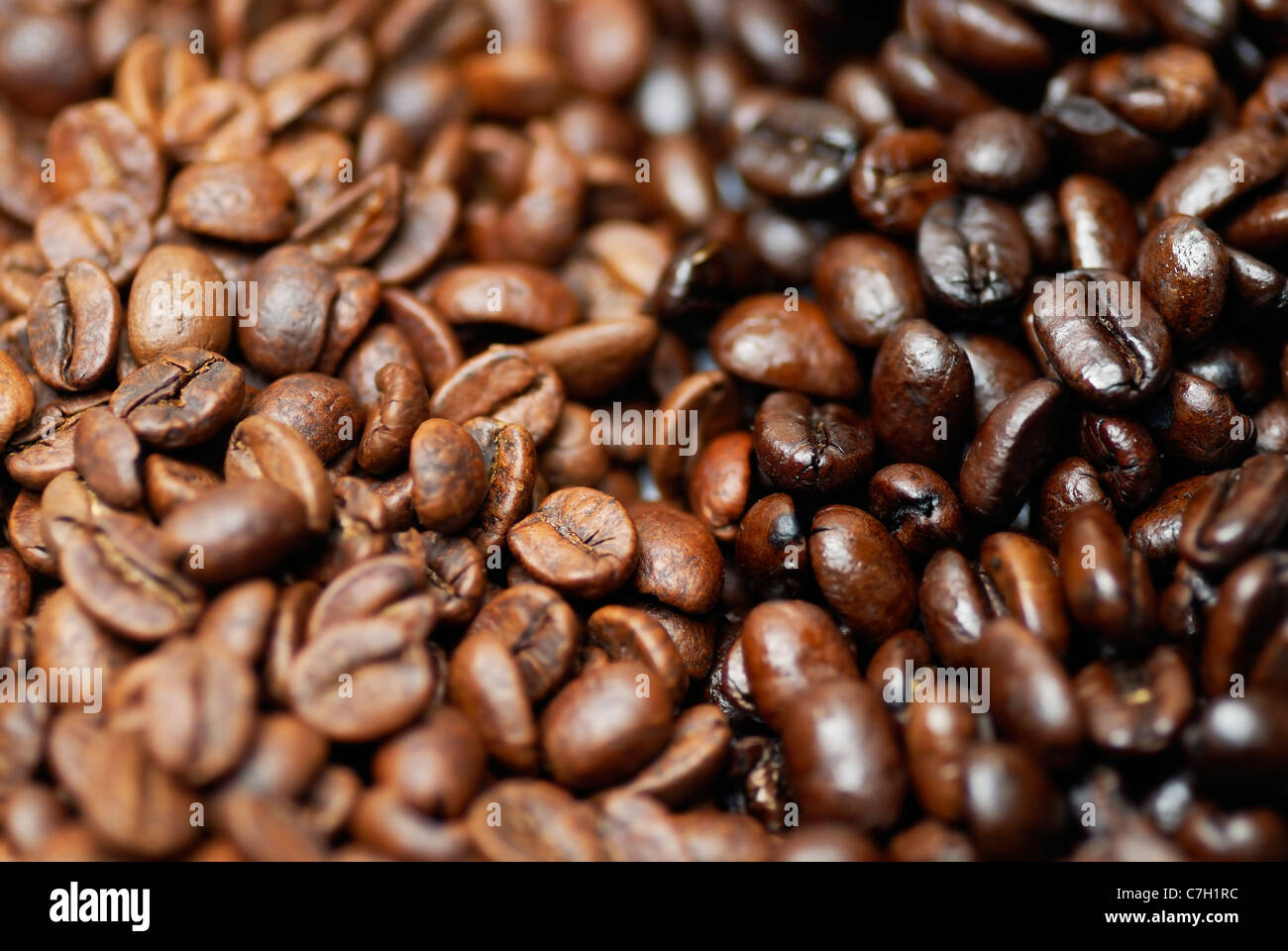 Decaffeinated and caffeinated coffee beans piled next to each other ... Decaffeinated and caffeinated coffee beans piled next to each other ...
