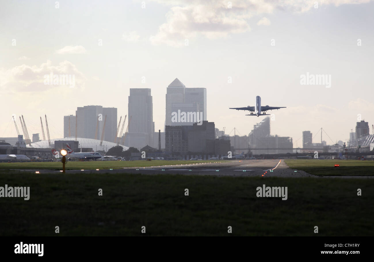 passenger aircraft taking off from London City airport with docklands ...