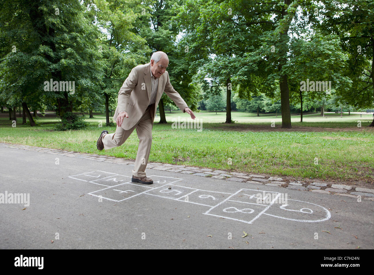 Senior man playing hopscotch in the park Stock Photo - Alamy