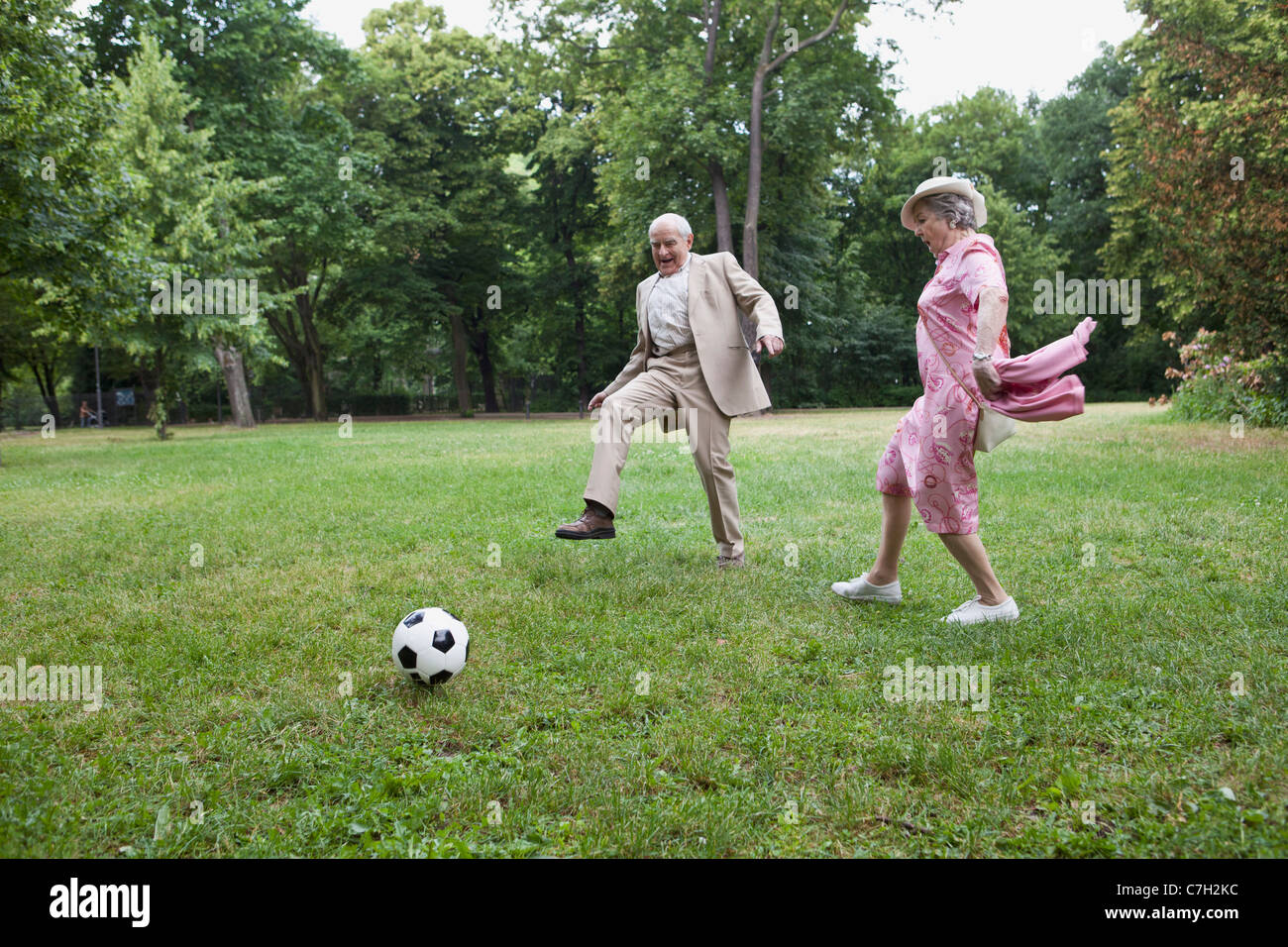 Adults playing soccer in the park hi-res stock photography and images ...