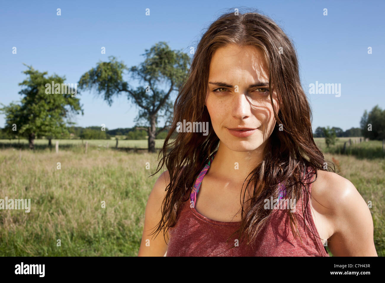 Profile of long haired girl in secluded field Stock Photo - Alamy
