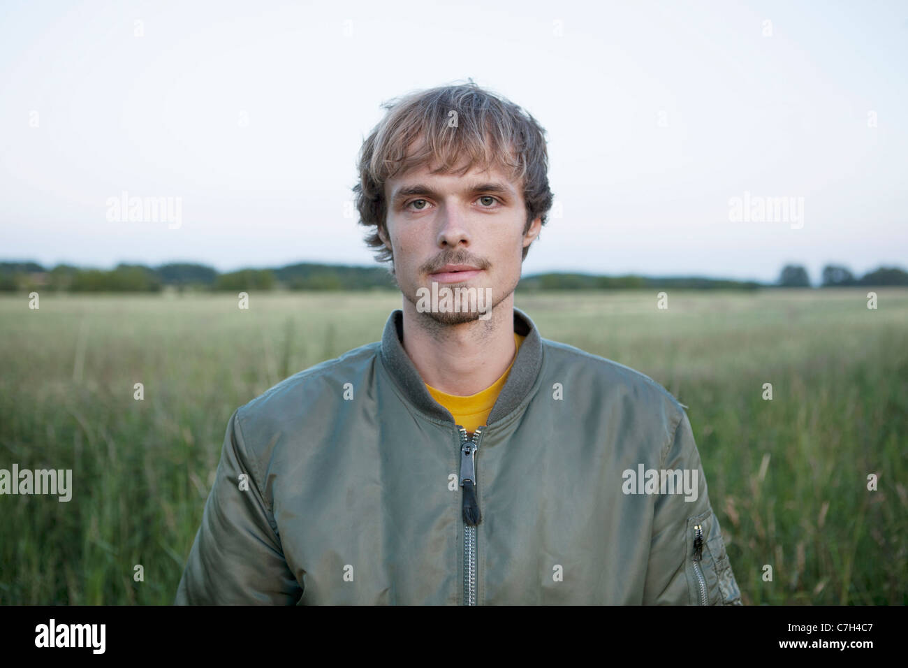 Profile of man standing in field Stock Photo - Alamy