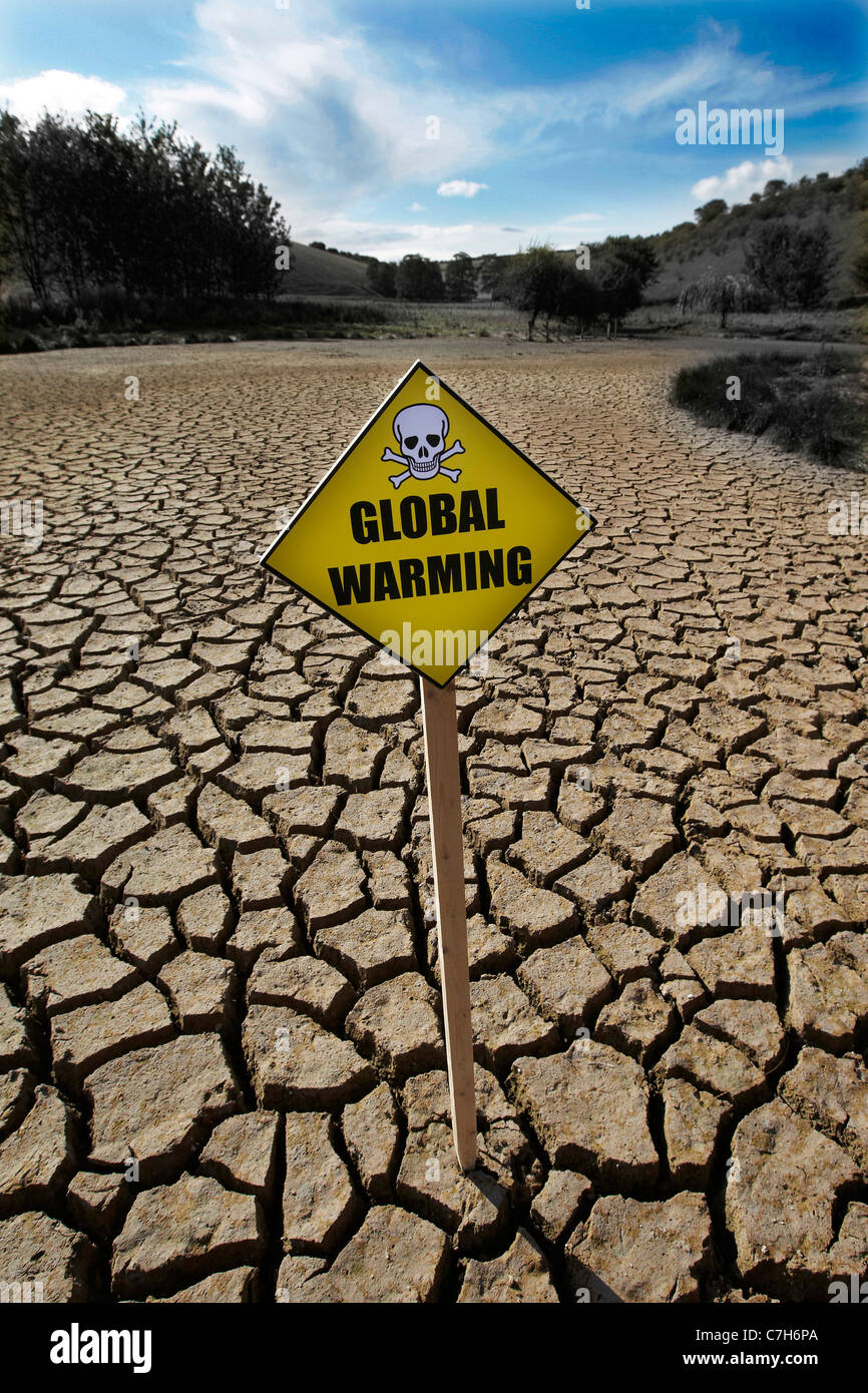 Global warming sign on cracked dried river bed mud Stock Photo - Alamy