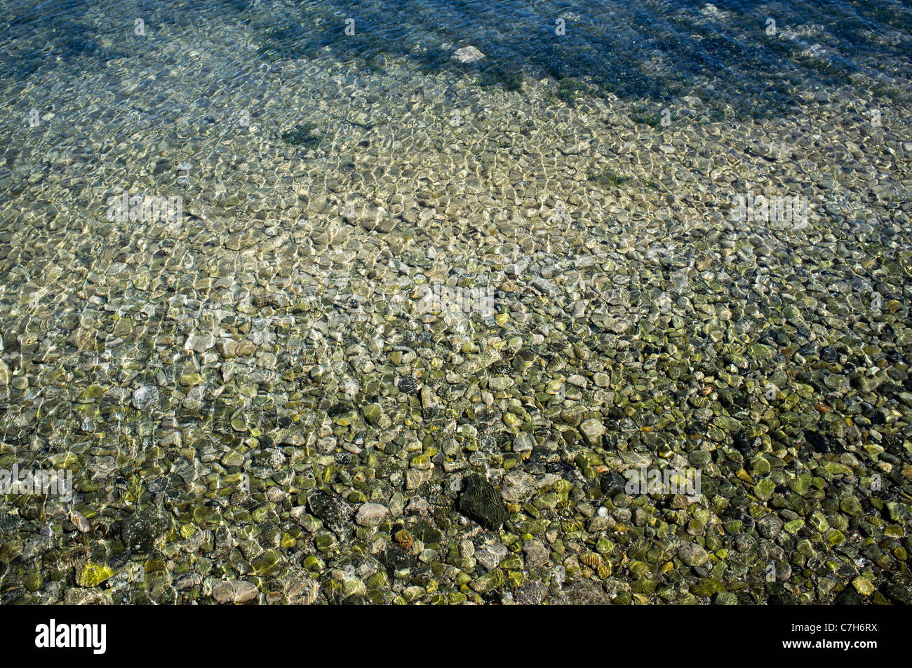Large pebbles under the water in the Bay of Mirabello on the Greek ...