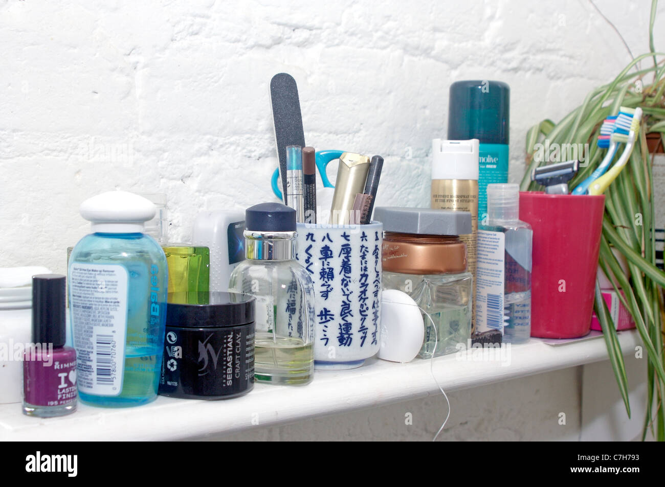 A shelf full of clutter in the bathroom of a home Stock Photo - Alamy
