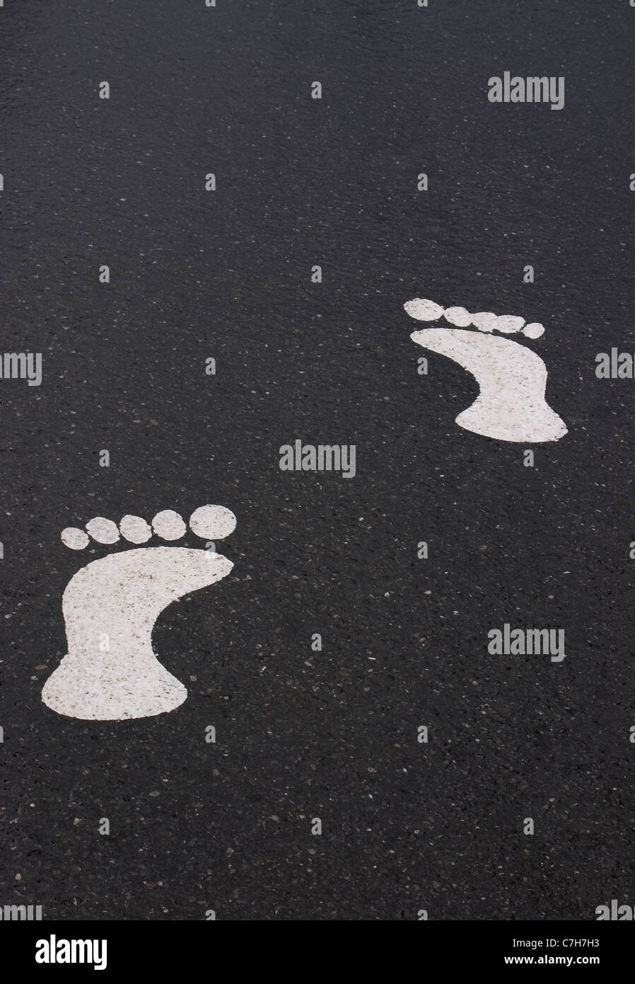 Painted footsteps on pavement Stock Photo - Alamy