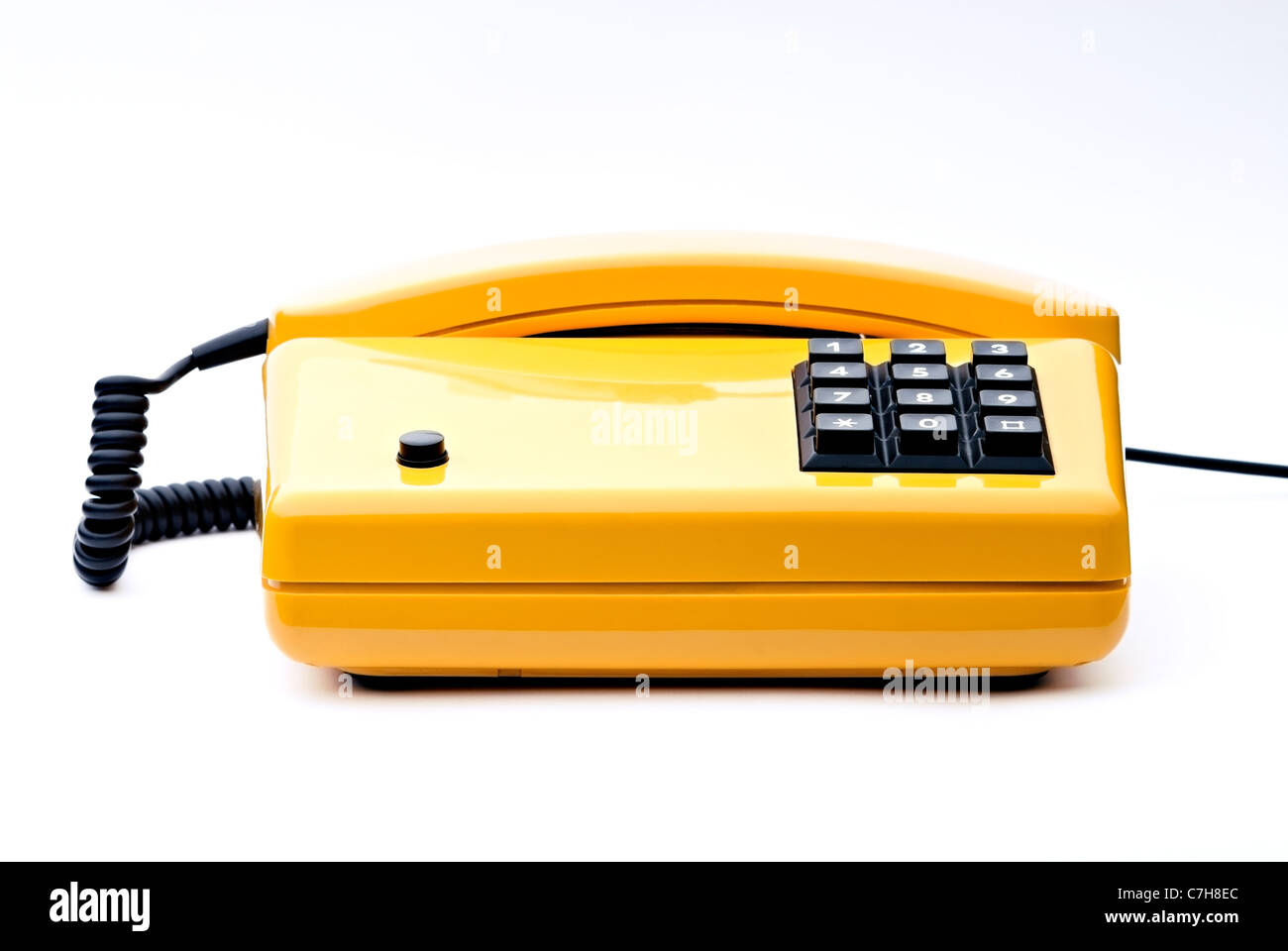 Old yellow keypad telephone 70s, isolated on white with shadow Stock ...