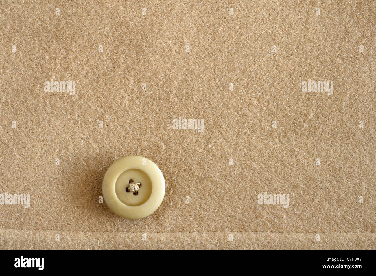 Button on wool fabric Stock Photo - Alamy