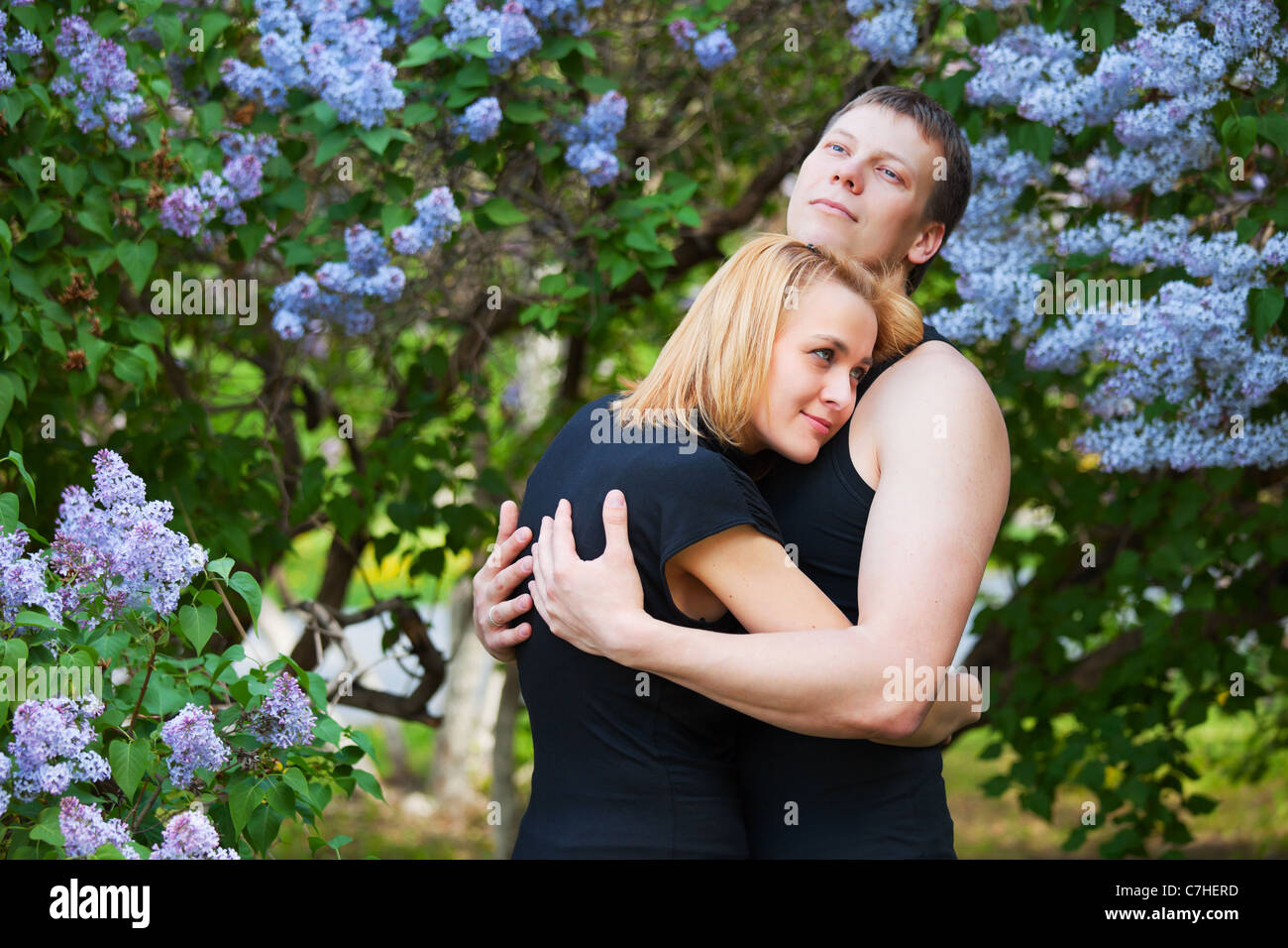 Happy young couple in a spring garden Stock Photo - Alamy
