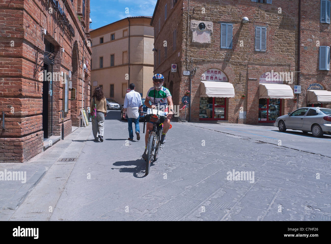 Middle aged male bicycle rider with helmet and biking jersey riding in ...