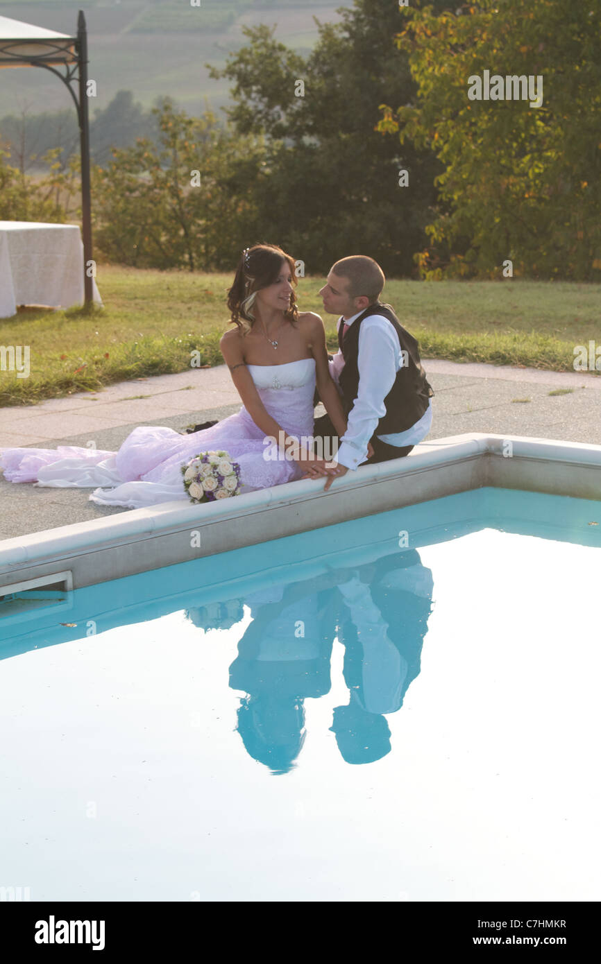 bride and groom near swimming pool Stock Photo - Alamy