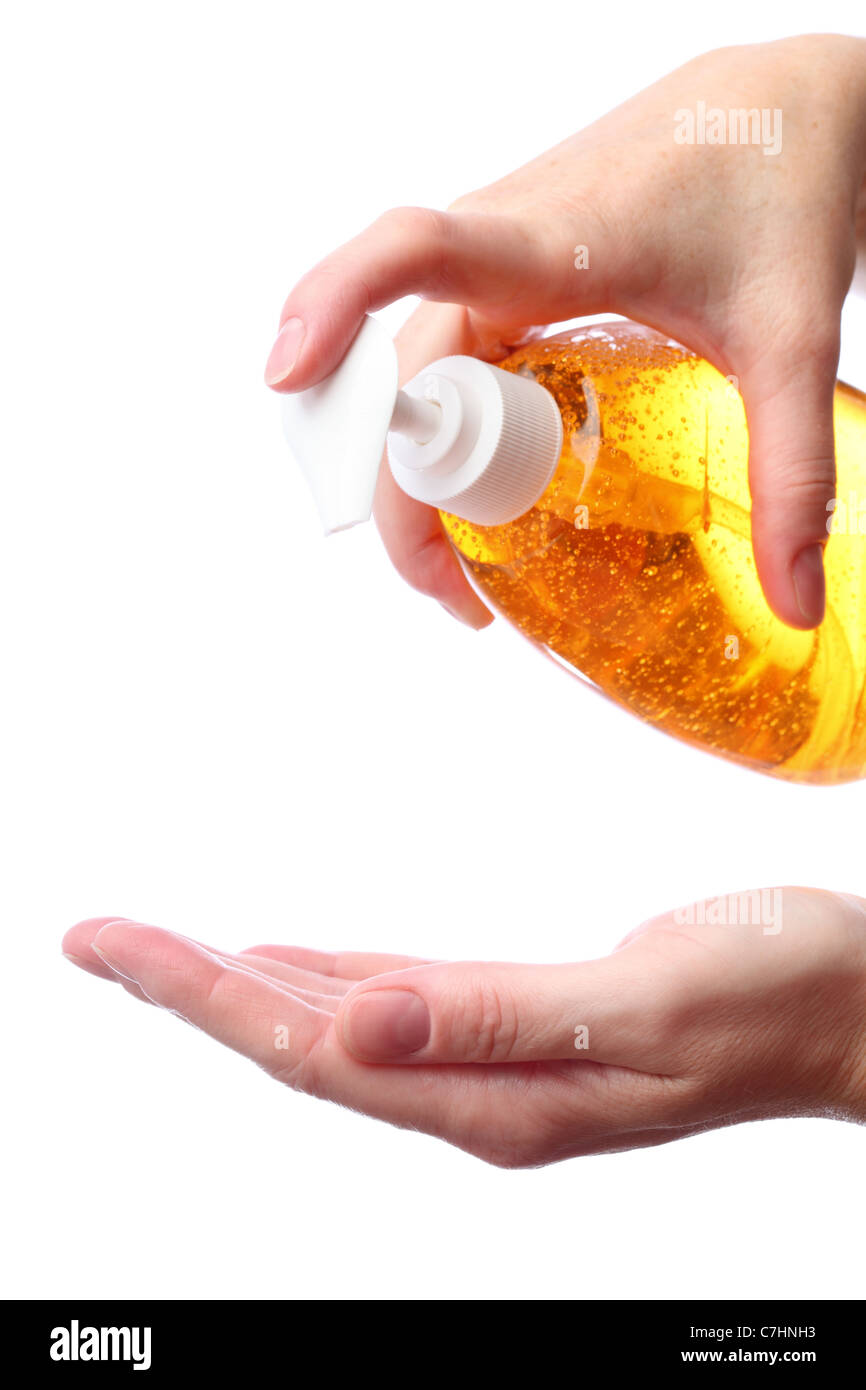 Applying liquid soap. Two hands holding bottle with liquid soap ...