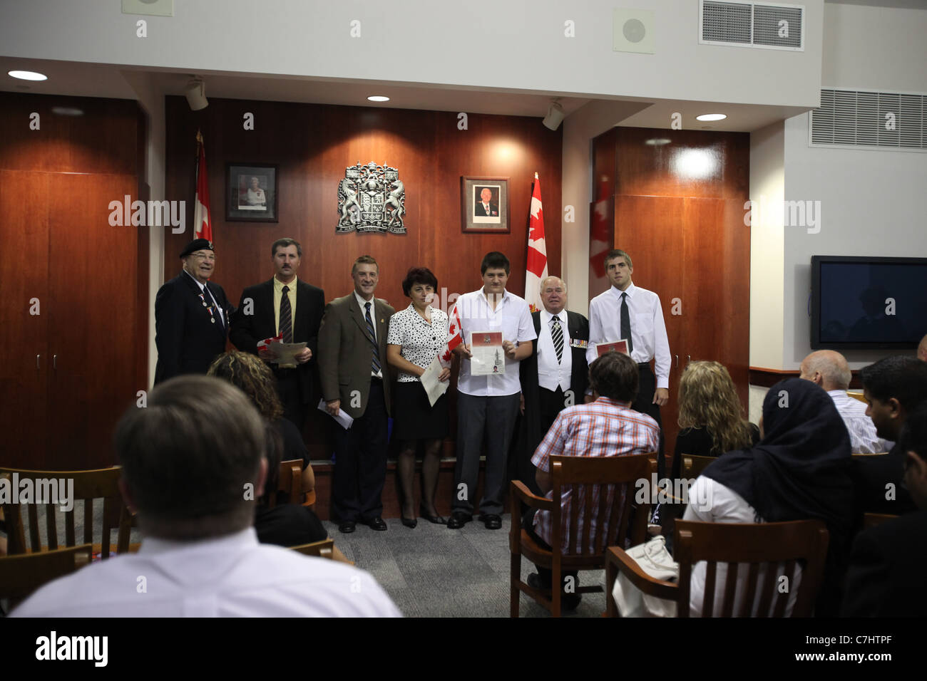Family of new Canadian citizens taking pictures in a citizenship ...