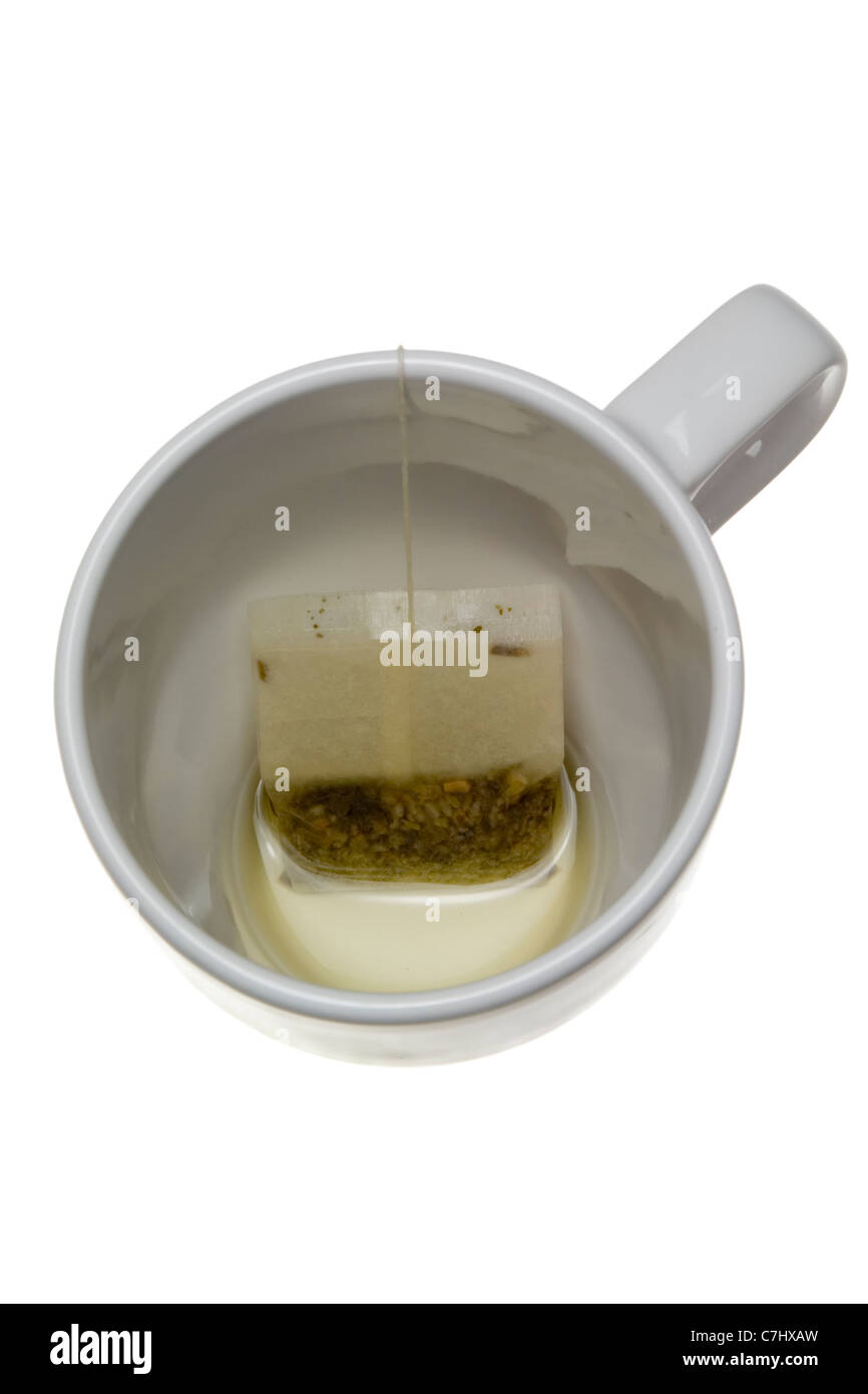 Teabag in an empty cup isolated on white background Stock Photo - Alamy
