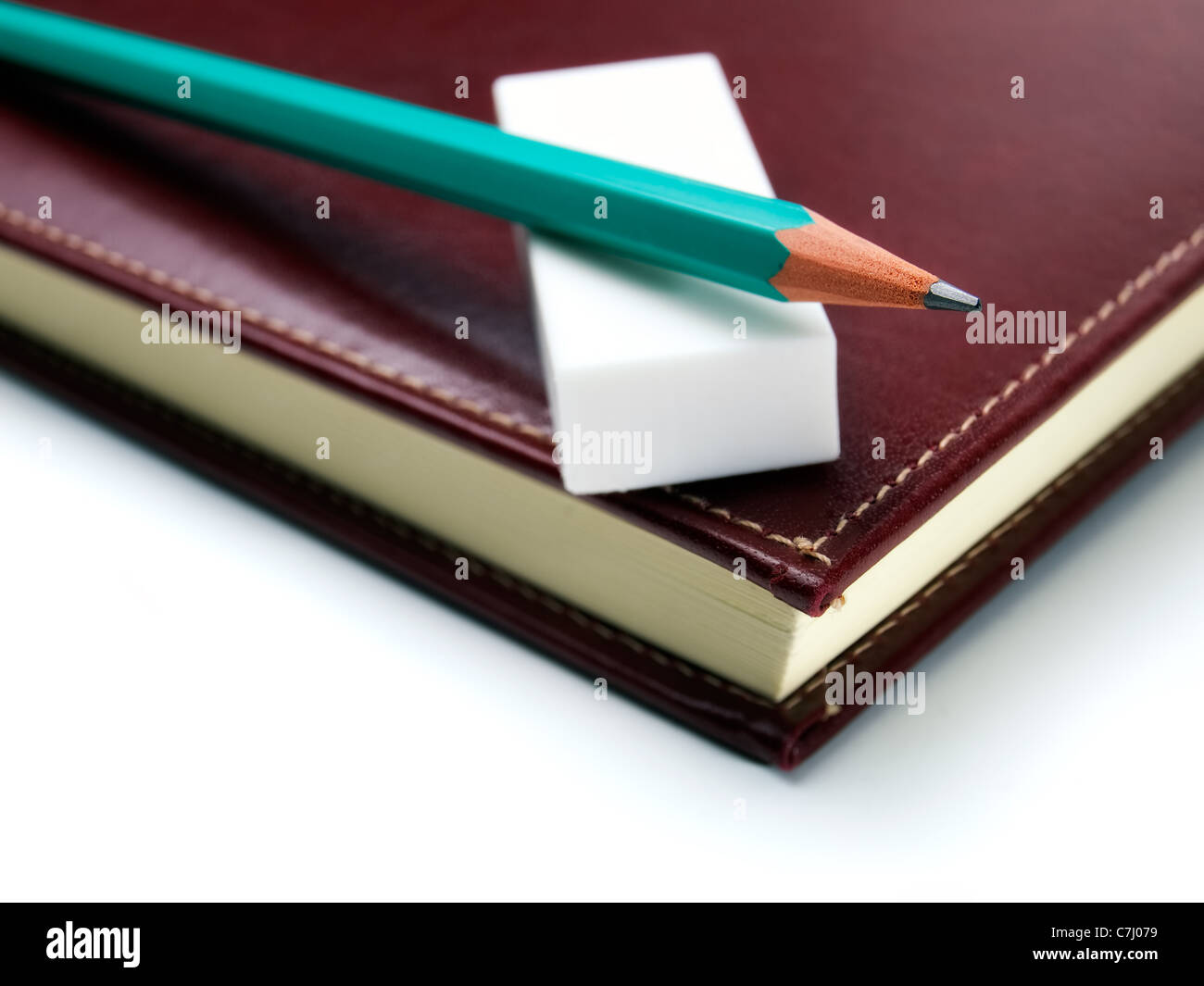 Pen and eraser on diary book on a white background Stock Photo - Alamy