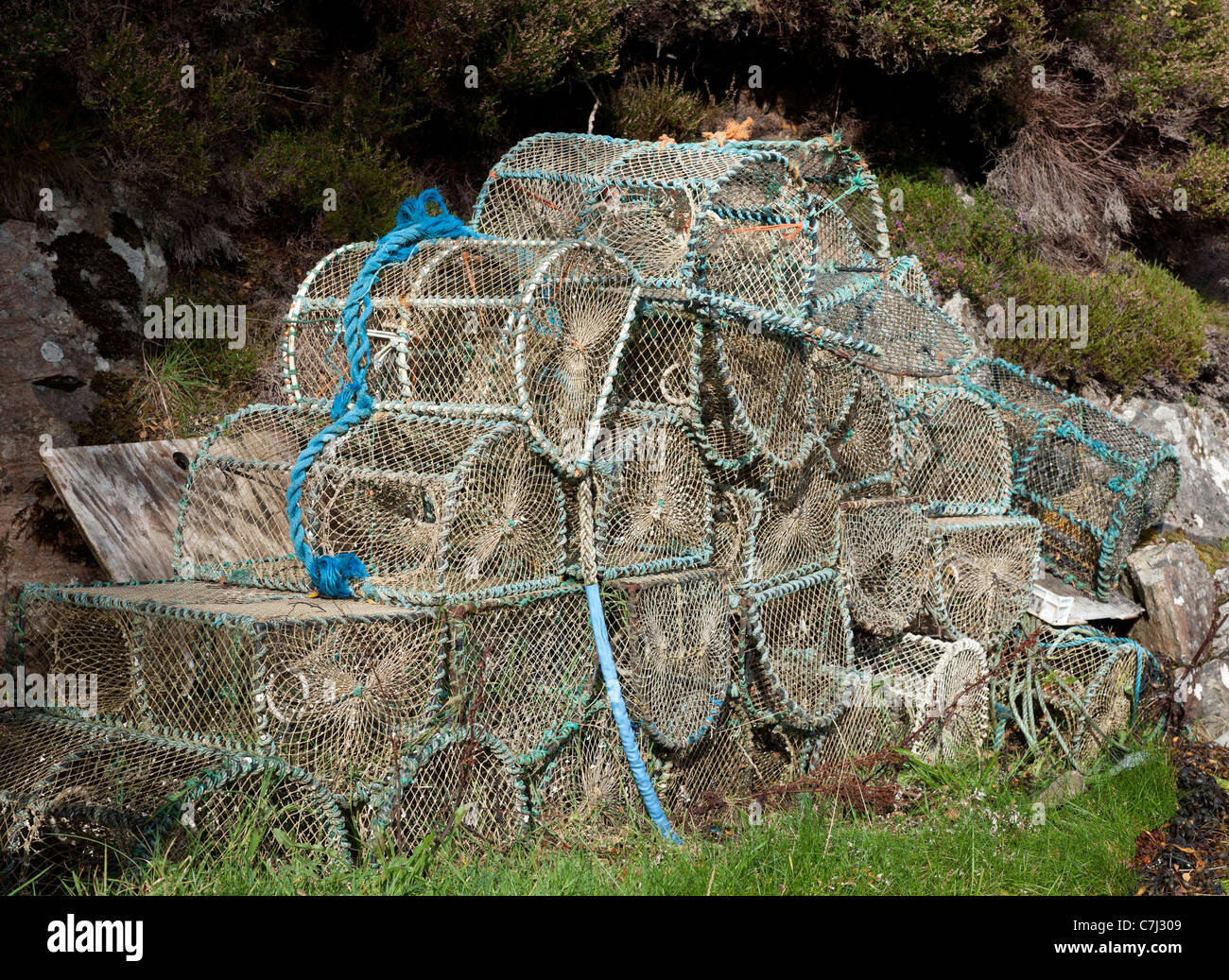 Lobster pots stored on the loch side of Loch Nedd, Sutherland, Scotland ...