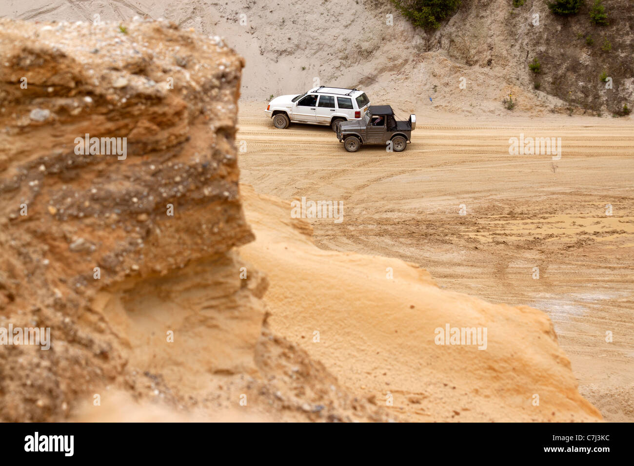four wheel cars driving in a sand pit Stock Photo - Alamy
