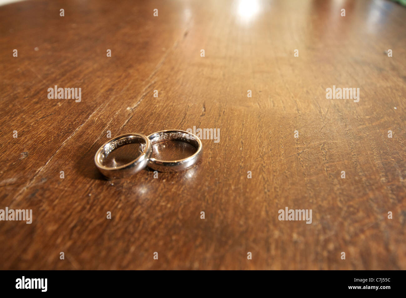 wedding rings on a table Stock Photo - Alamy