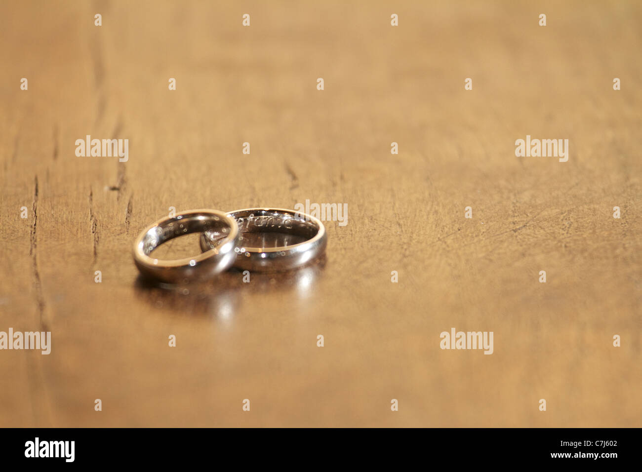 wedding rings on a table Stock Photo - Alamy