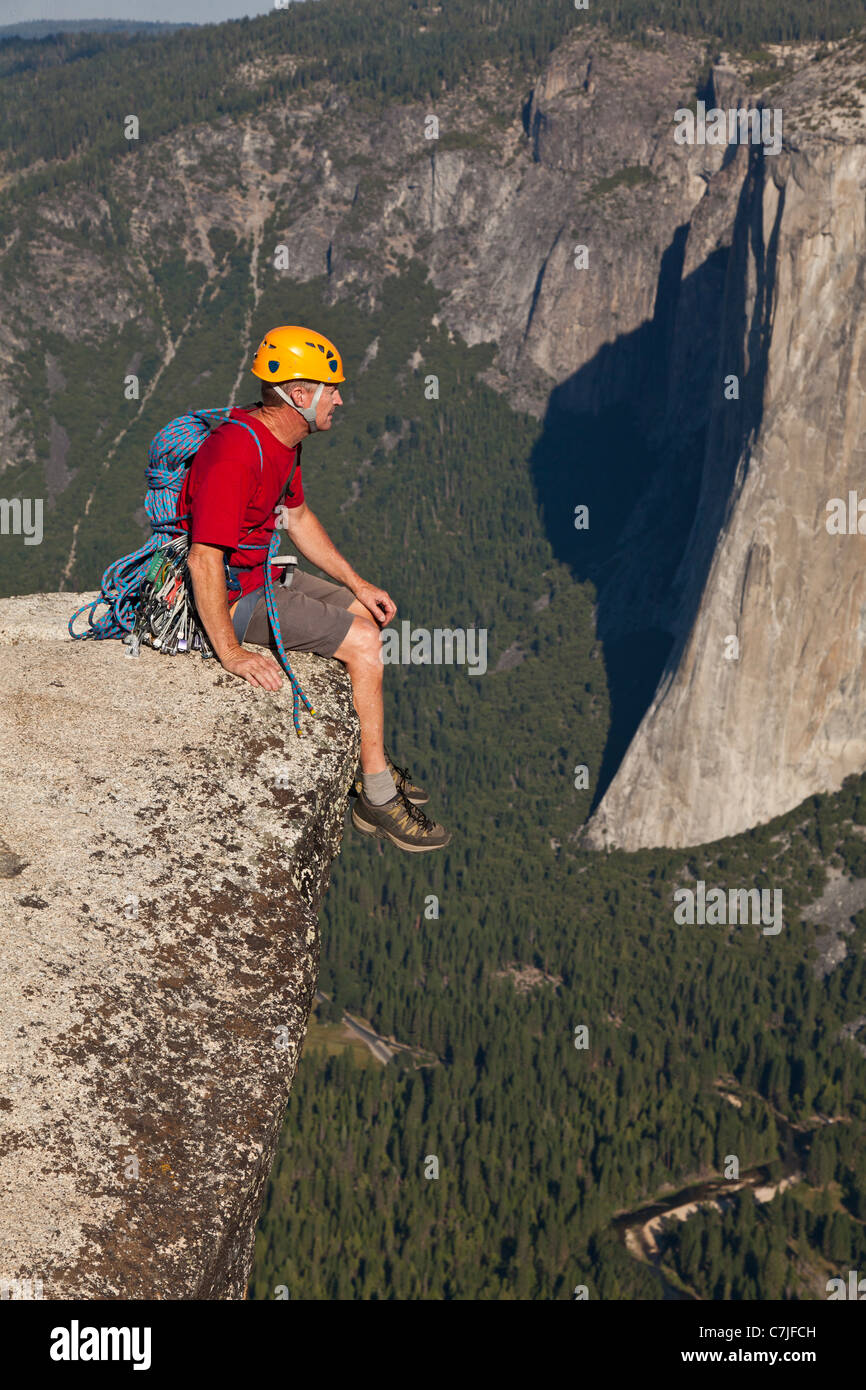 Male rock climber celebrates on the summit after a successful ascent ...