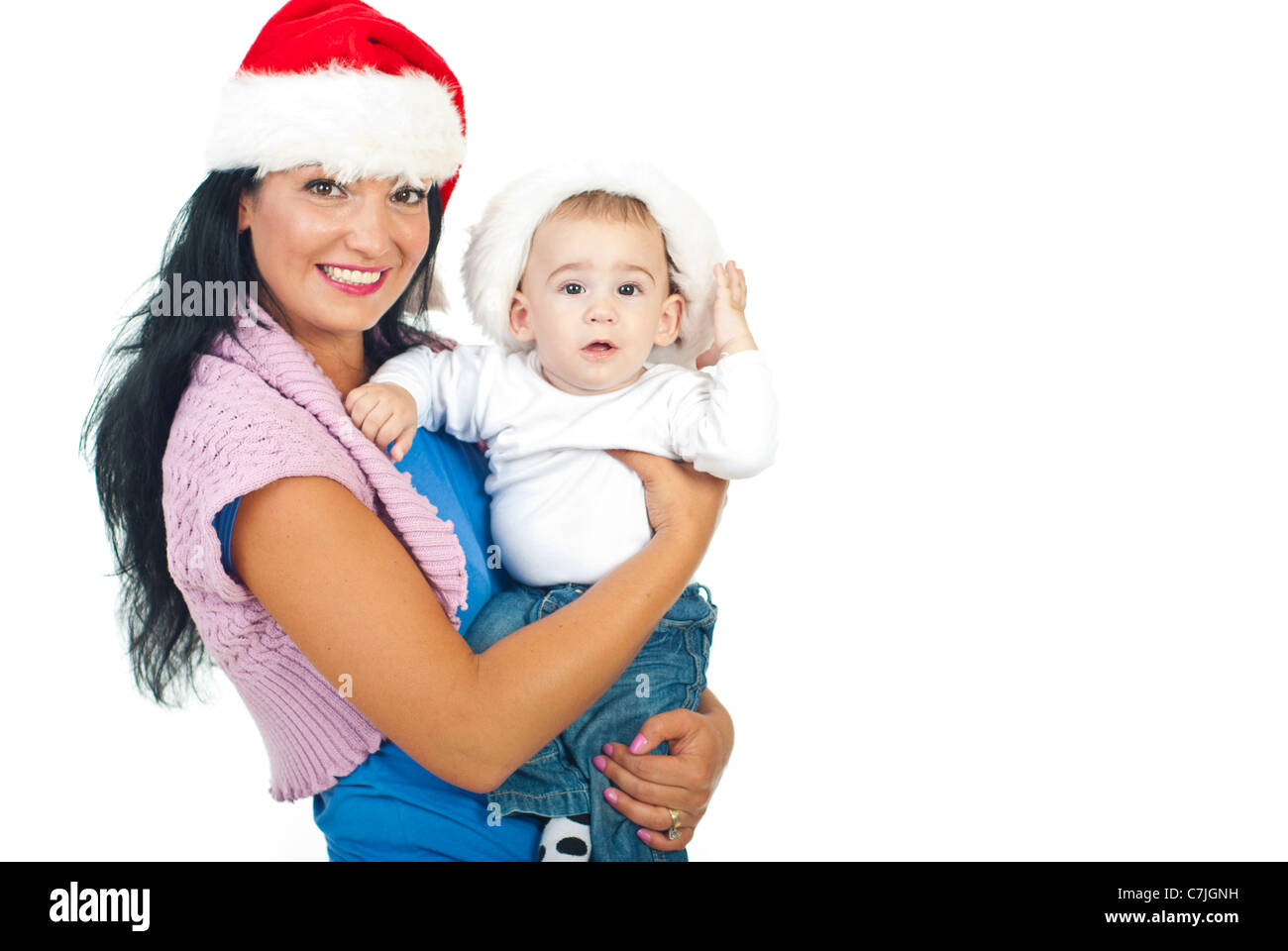 Mother and baby wearing Santa hats and smiling isolated on white ...