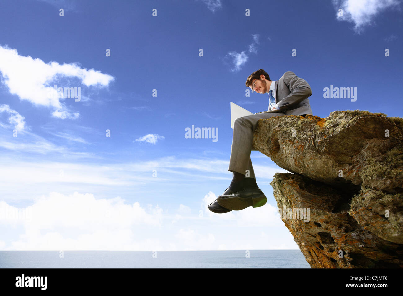 Man laptop sitting on cliff hi-res stock photography and images - Alamy