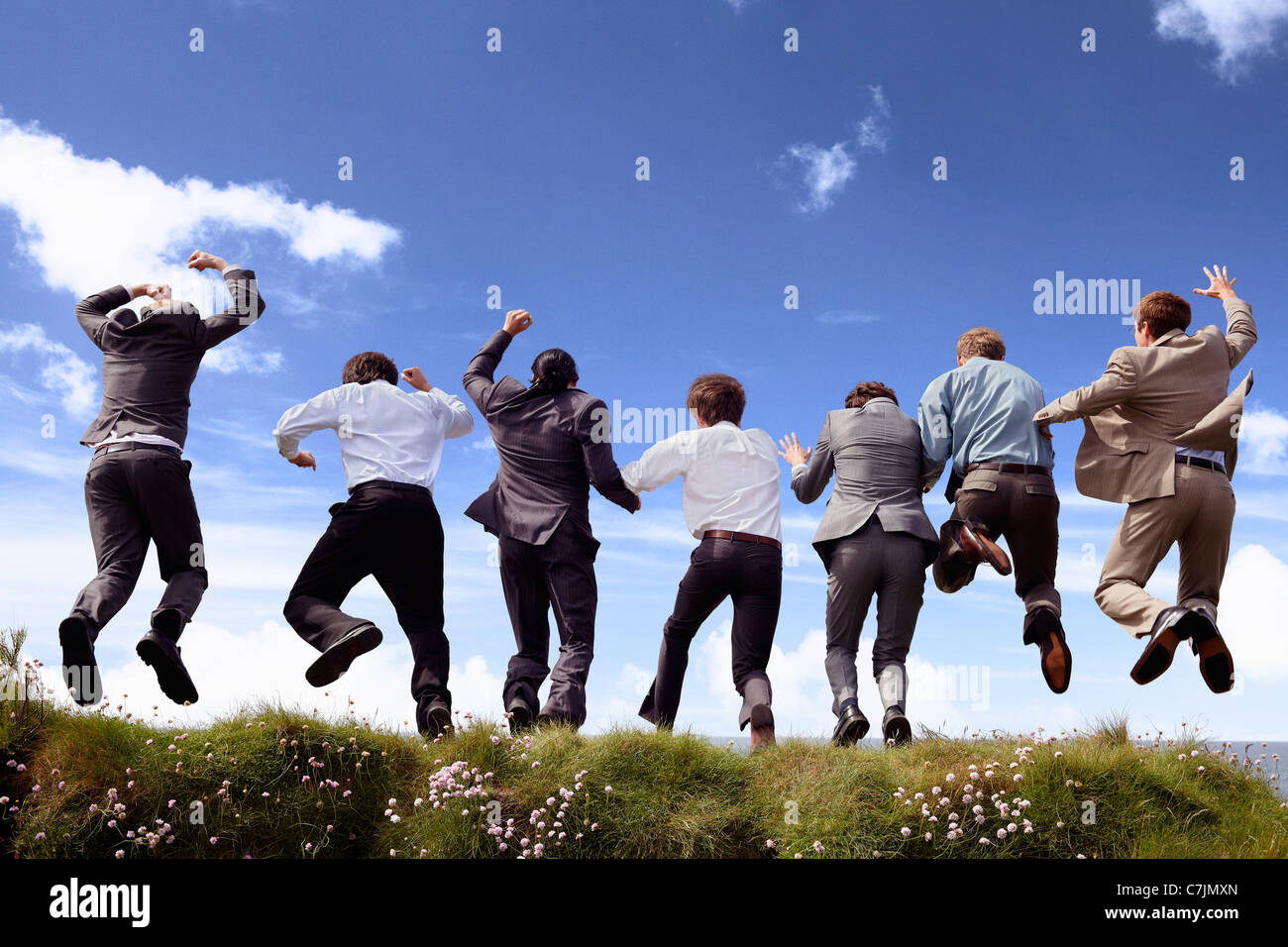 Businessmen jumping for joy outdoors Stock Photo - Alamy