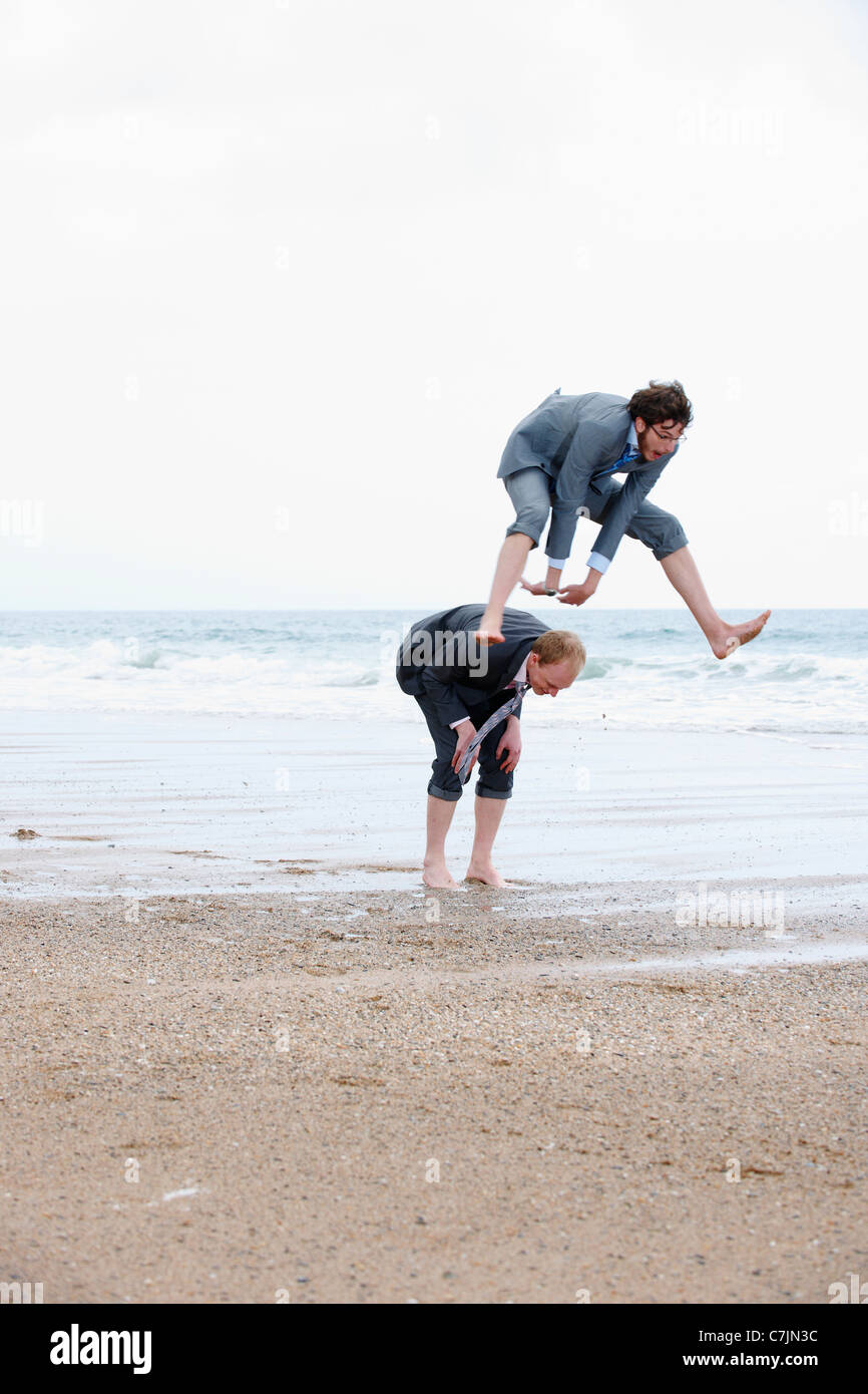 Businessmen playing on beach Stock Photo - Alamy