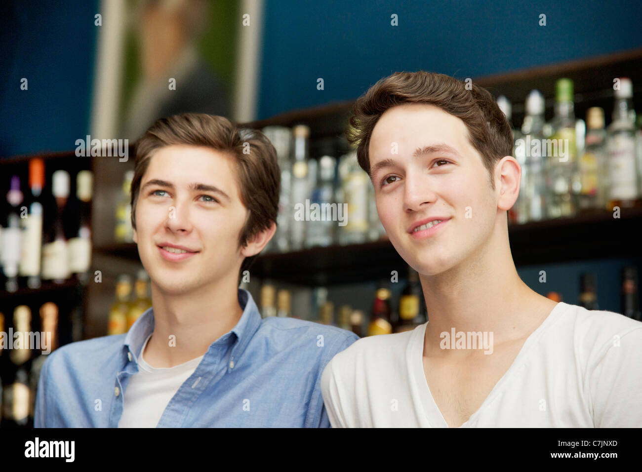 Smiling men in bar Stock Photo - Alamy