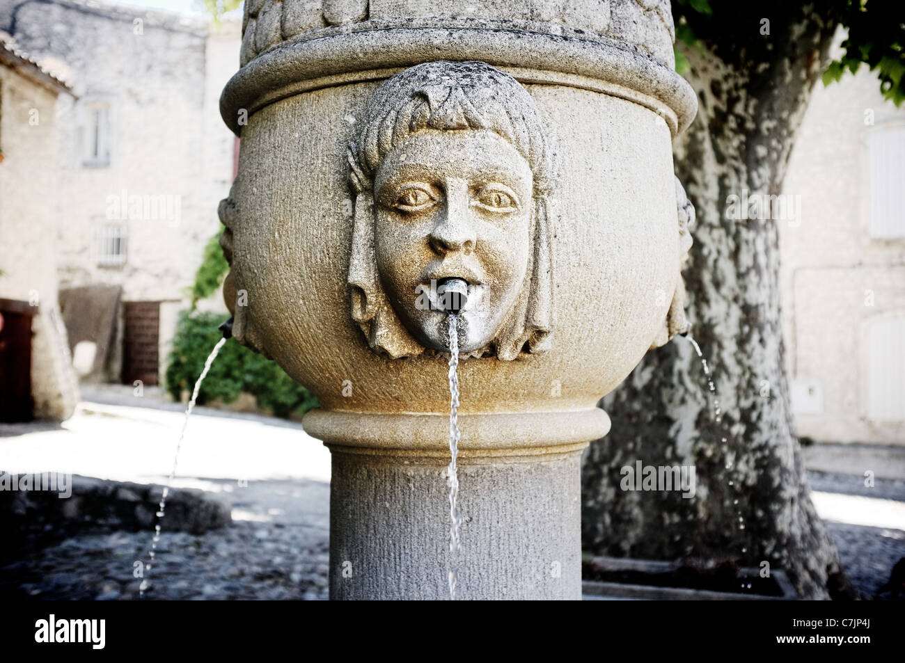 Close-up of a roman fountain with water flowing Stock Photo - Alamy