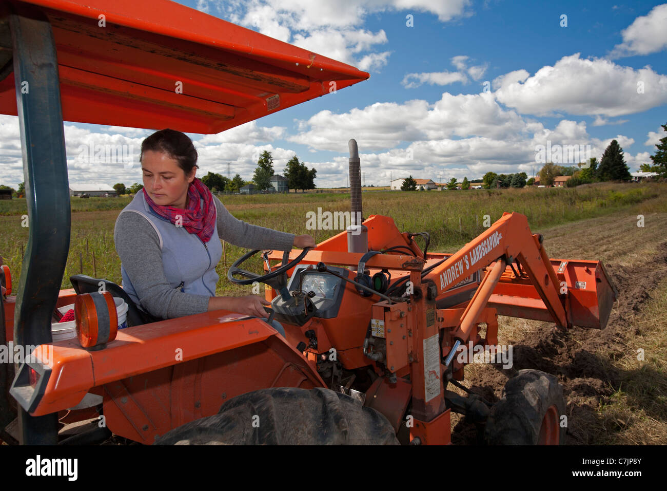 Tractor Driver on Organic Farm Stock Photo - Alamy