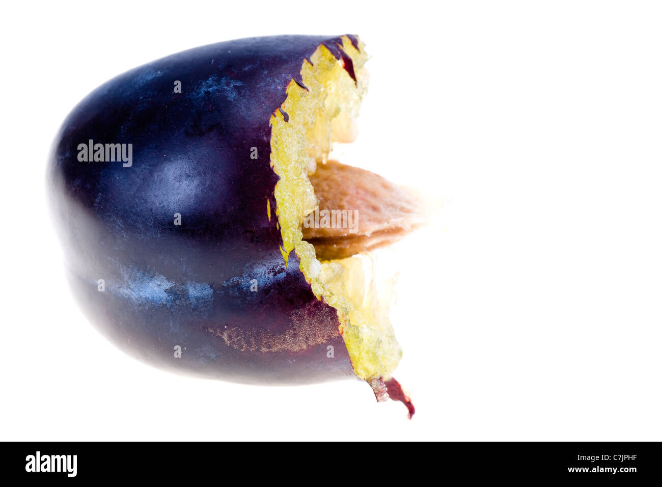 Bitten blue plums isolated Stock Photo - Alamy