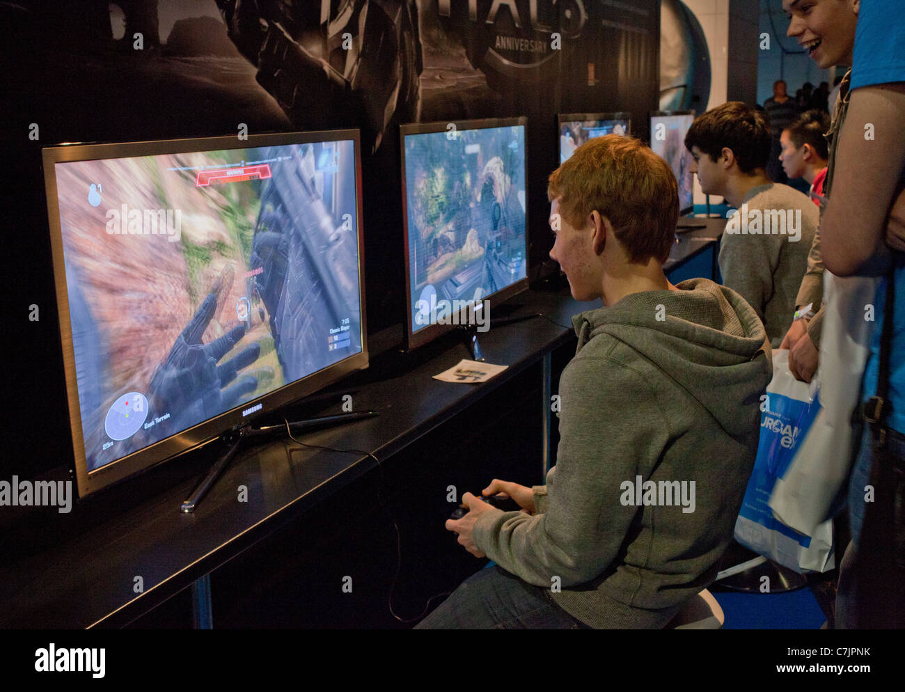 Young people trying latest PC and console games at a trade fair in ...