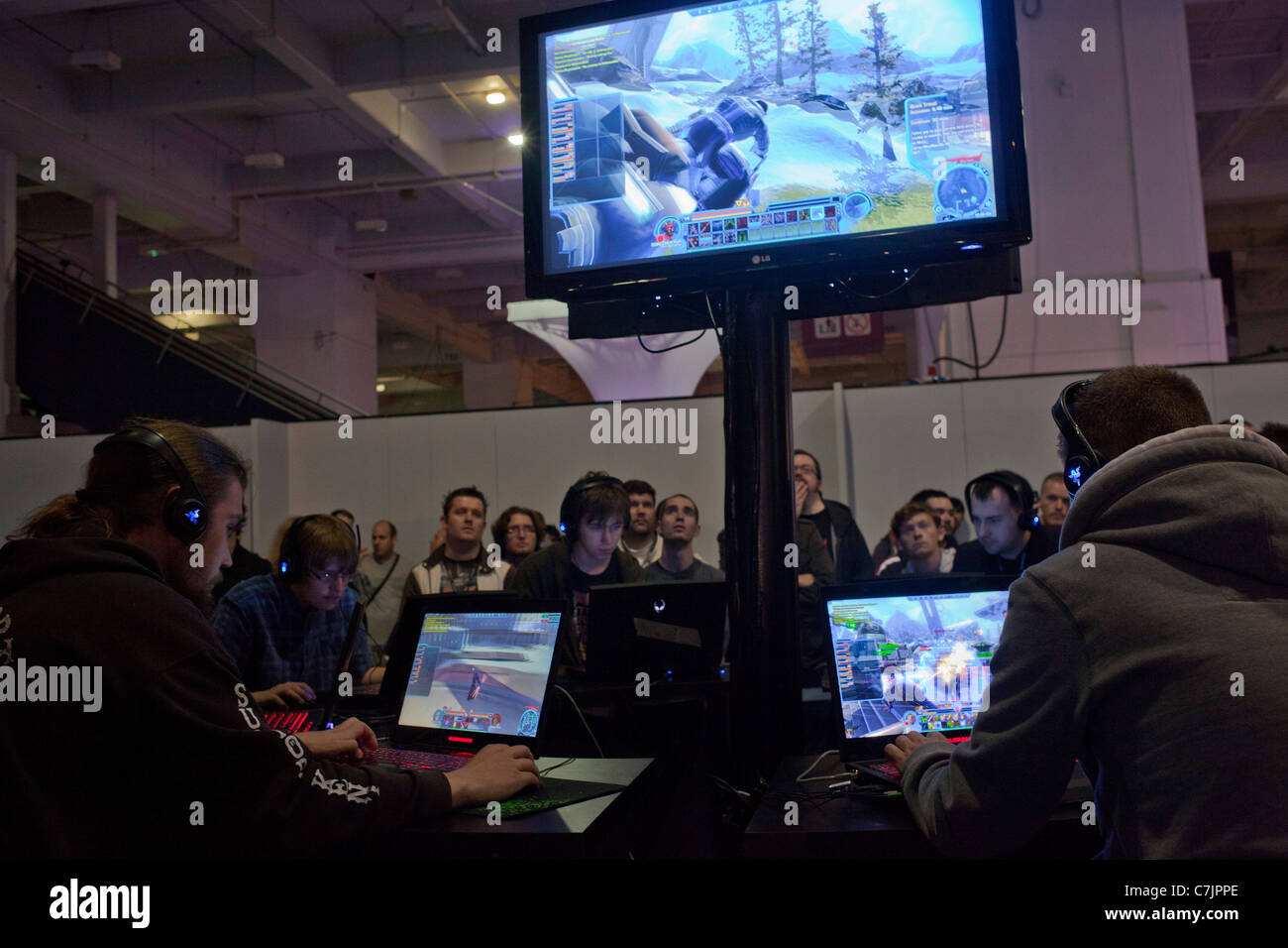 Young people trying latest PC and console games at a trade fair in ...