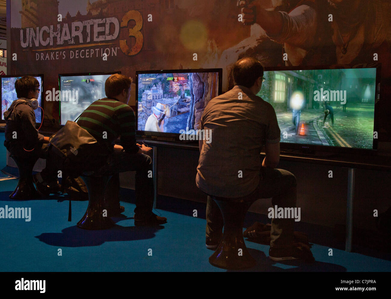Young people trying latest PC and console games at a trade fair in ...
