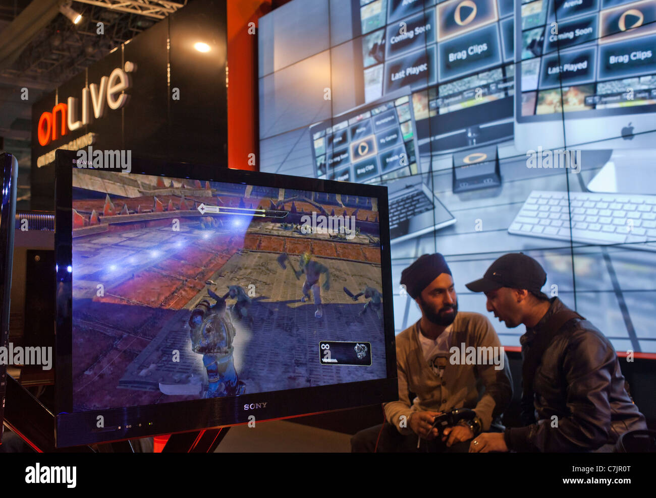 Young people trying latest PC and console games at a trade fair in ...