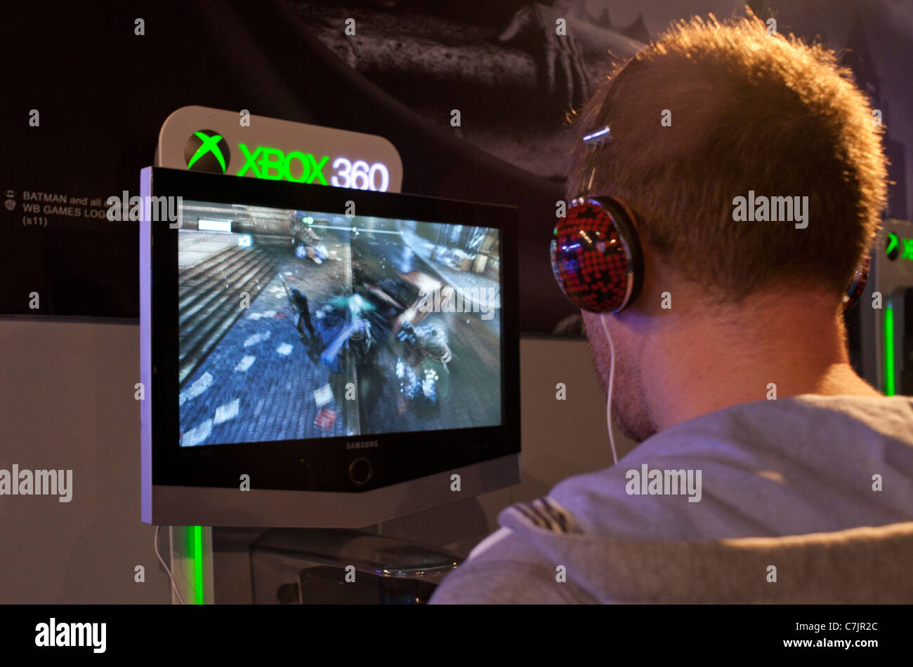 Young people trying latest XBox and console games at a trade fair in ...