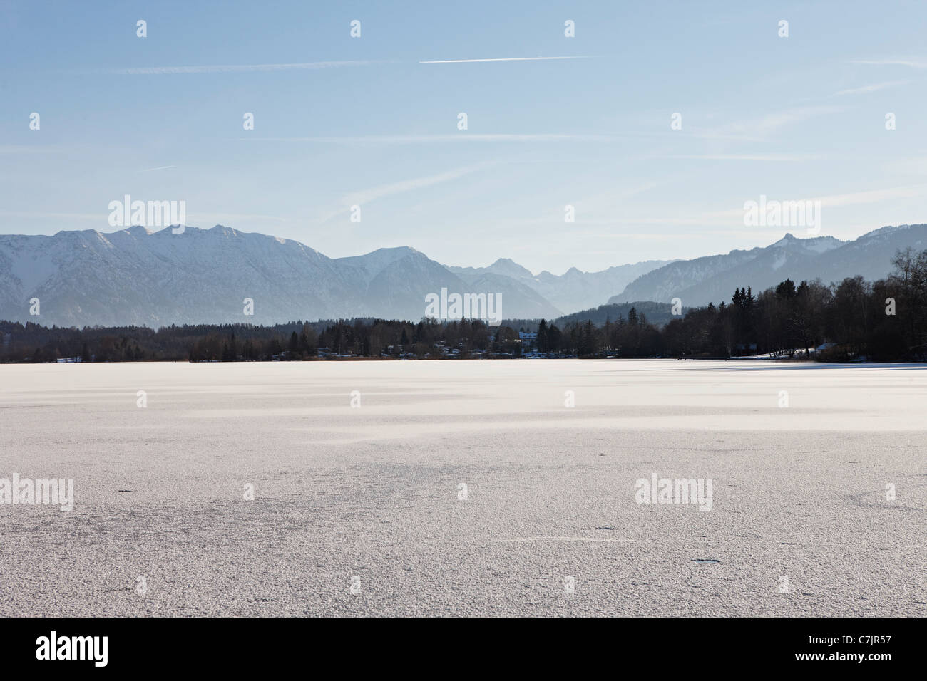 Mountains lining snow covered field Stock Photo - Alamy