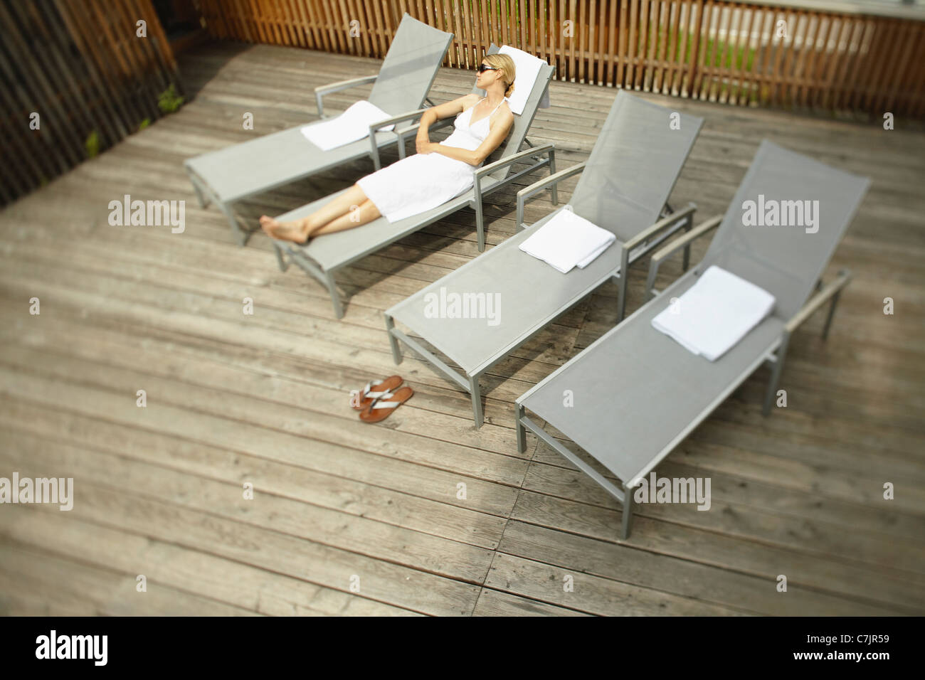 Woman sunbathing in lawn chair Stock Photo - Alamy